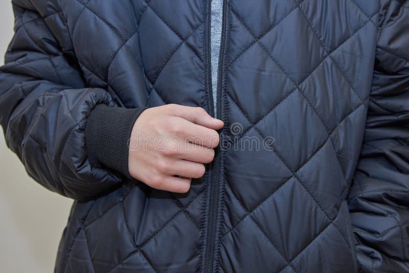 Put on a Jacket,the Boy Puts on a Black Jacket, Fastens the Zipper ...