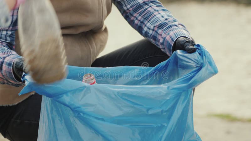 Put Plastic Trash in a Bag. Cleaning the Park, Taking Care of the ... Put Plastic Trash in a Bag. Cleaning the Park, Taking Care of the ...