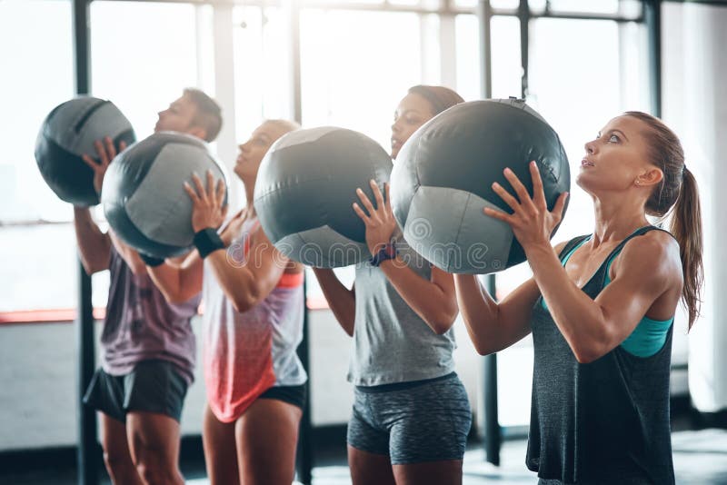 Put in the Work. Shot of a Fitness Group Working Out at the Gym. Stock ...