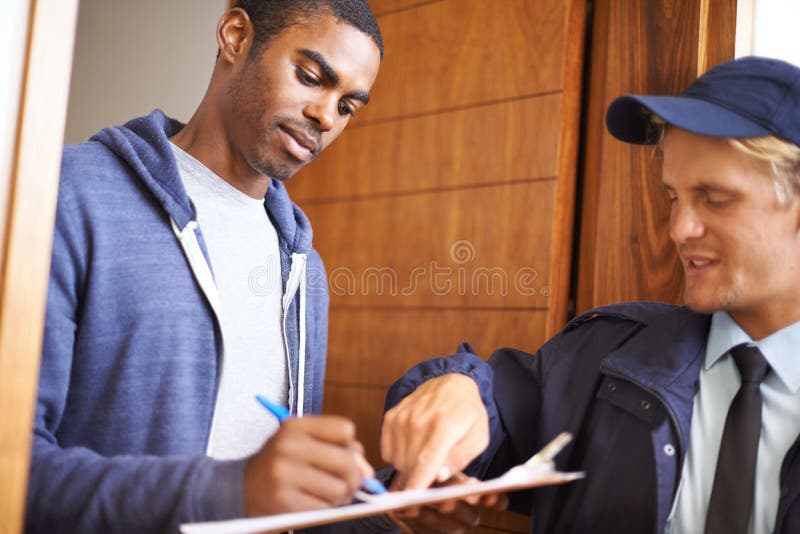 Put Your Name Right Here. Shot of a Handsome Young Man Signing a Form ...