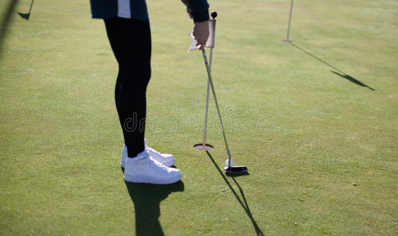 Putter To Ball and Takes Aim at Golf Course Stock Image - Image of club ...