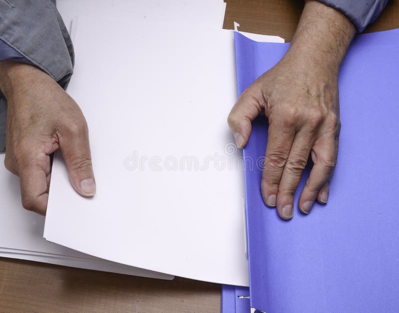 Putting Away Paper in a Folder for Organization ,work,order and Future ...