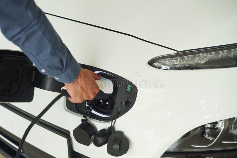 Putting Charger into Electrical Car Socket. Close Up View of Man Stock ...