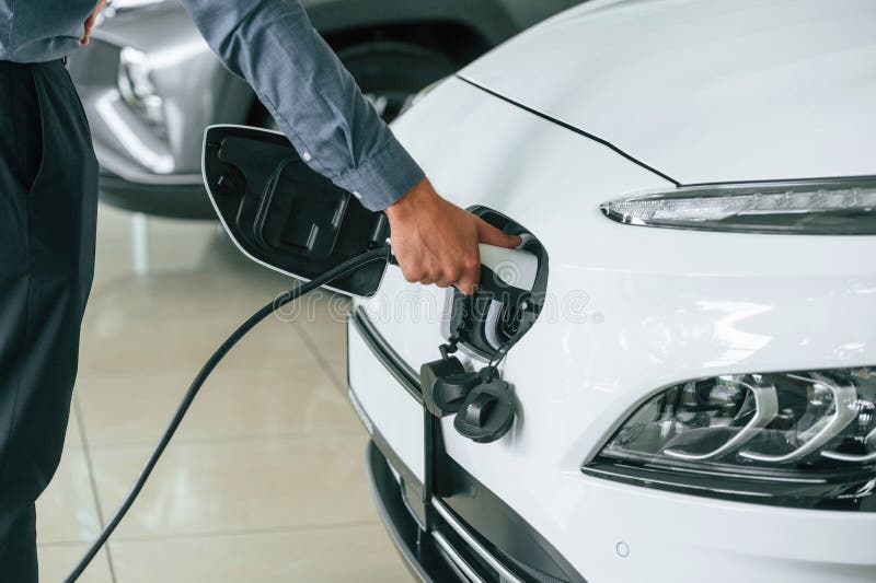 Putting Charger into Electrical Car Socket. Close Up View of Man Stock ...