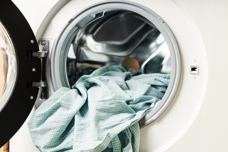 Putting Clothes into the Drum of a Washing Machine Front View Washing ...