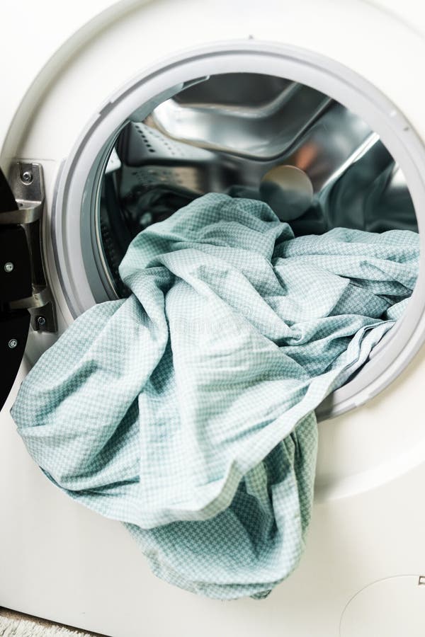 Putting Clothes into the Drum of a Washing Machine Front View Washing ...