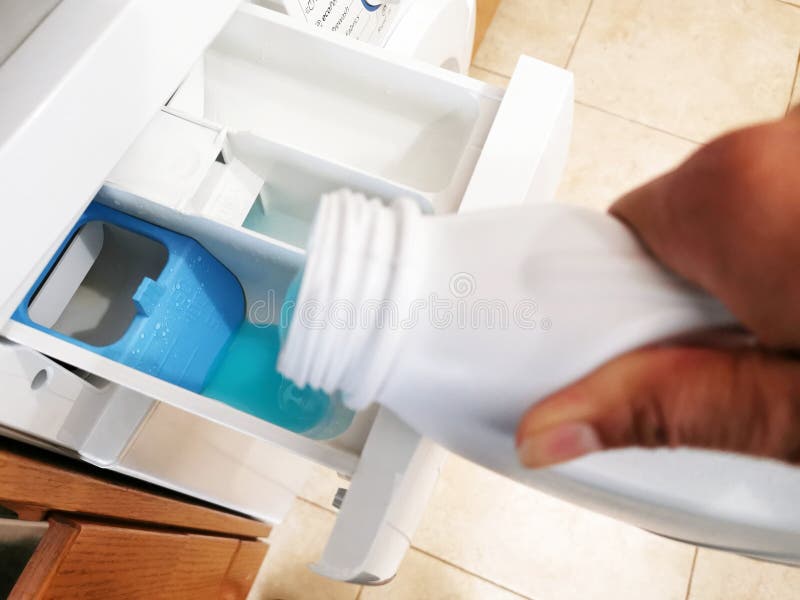 Putting Fabric Detergent Liquid in Washing Machine. Stock Photo - Image ...