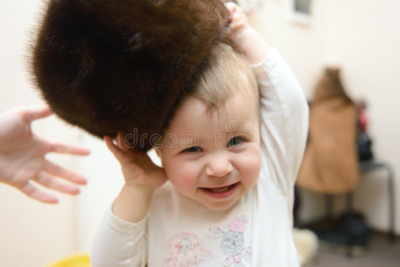 Putting on Fur Cap stock image. Image of beauty, human - 37709247