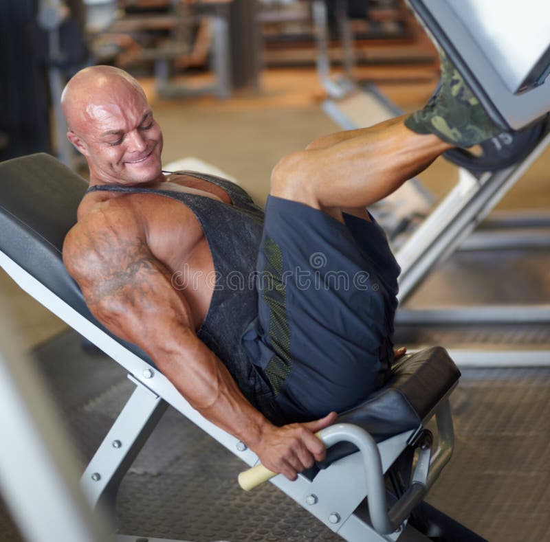 Putting His Legs into it. a Male Bodybuilder Doing Leg Exercises on a ...