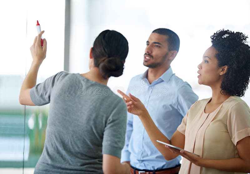 Putting Ideas into Practice. a Diverse Group of Coworkers Brainstorming ...