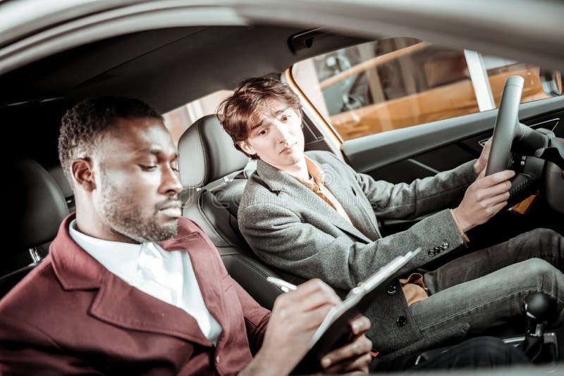 Driving Instructor Putting Marks after Driving To Young Student Stock ...