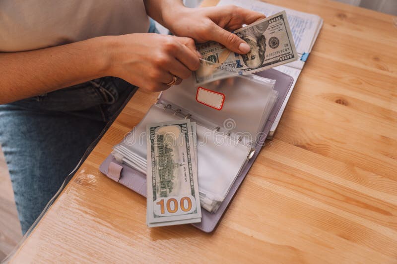 Putting Money into Different Zip Bags in a Notepad Stock Image - Image ...