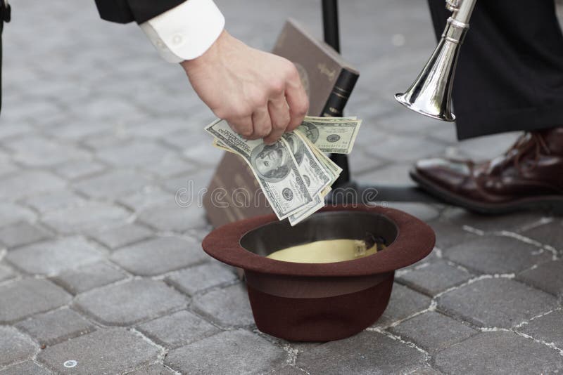 Putting money in the hat stock image. Image of giving - 15904173