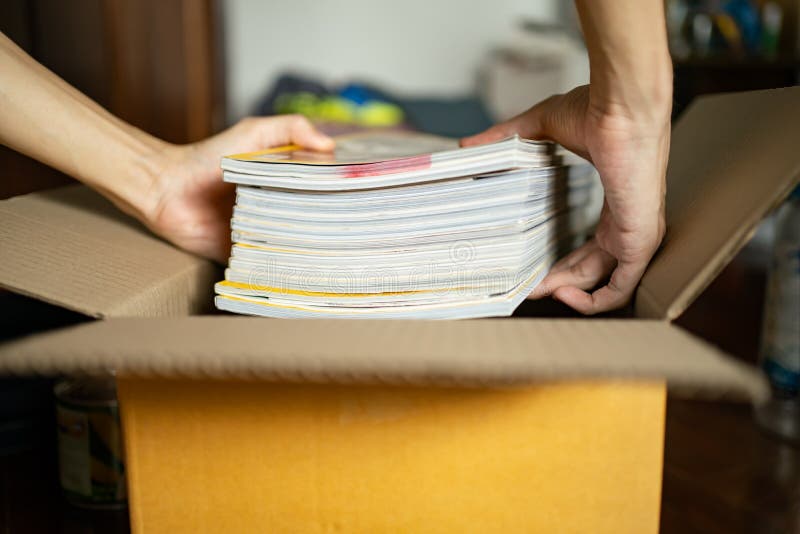 Putting Old Magazines into a Cardboard Box Stock Photo - Image of ...