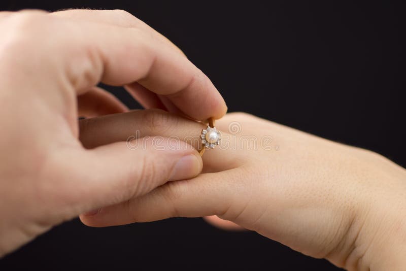 Male Hand Inserting Ring into a Finger Stock Image - Image of love ...