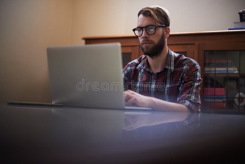 Putting in Some Long Hours Online. a Handsome Young Hipster Working on ...