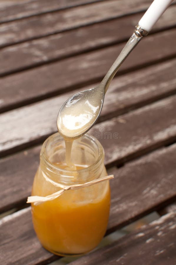 Putting Spoon into Liquid Honey Stock Photo - Image of honey, texture ...