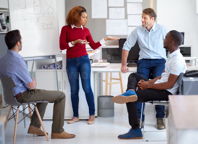 Putting Their Heads Together for an Awesome Design. a Group of Designer ...