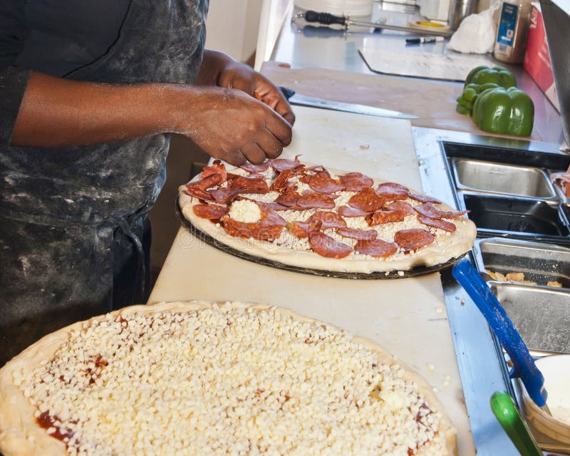 Putting Toppings on Pizza stock photo. Image of pizza - 25737488