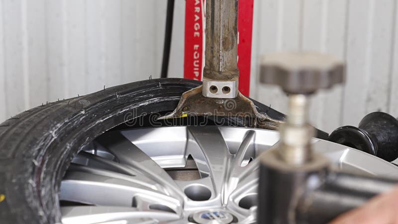 Putting the Tyre on the Disc. Assembling a Car Wheel Stock Footage ...