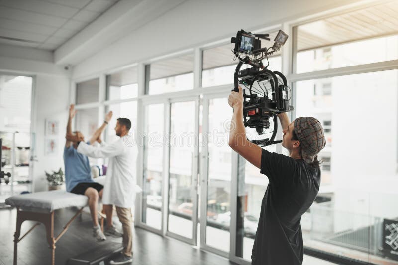 Putting it Up High. Behind the Scenes Shot of a Camera Operator ...