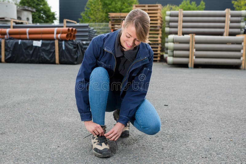 She putting work boots on stock image. Image of industry - 264392675