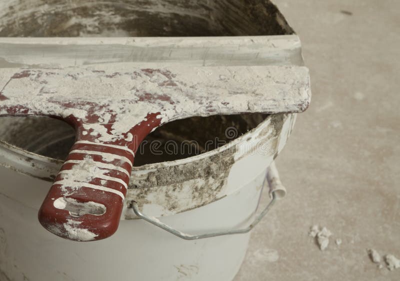 Putty knife and bucket stock photo. Image of construction - 21611038
