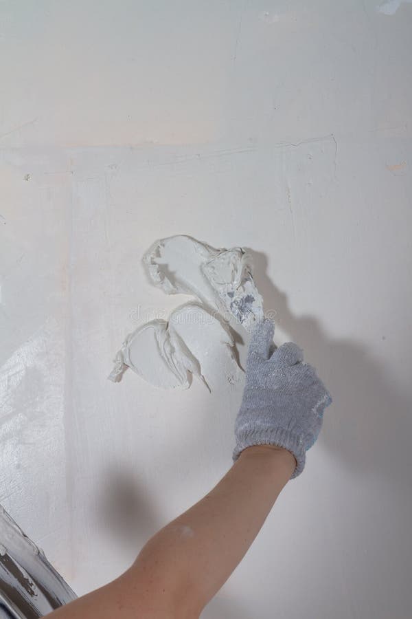 Putty the Wall in the House with Putty Using a Spatula To Level the ...