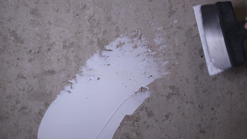 Puttying Process. a Female Gloved Hand Works with a Concrete Wall Stock ...