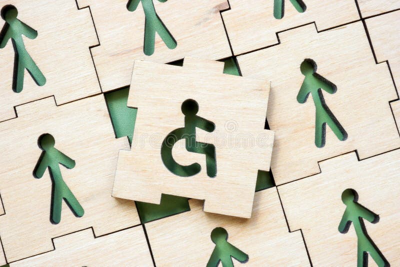 Puzzle Close-up with Figurines and Disability Person Sign. Inclusion ...