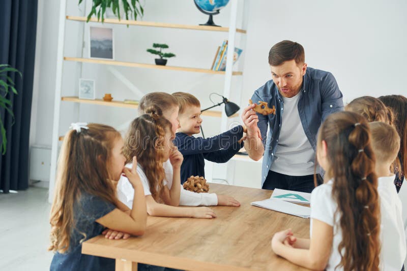 With Puzzle. Group of Children Students in Class at School with Teacher ...