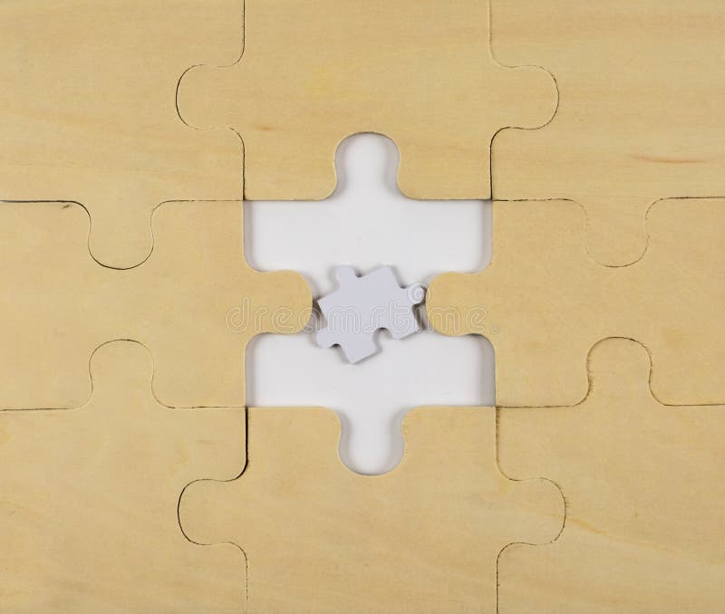 A Puzzle Made of Wood with a Too Small Piece in the Middle Stock Image ...