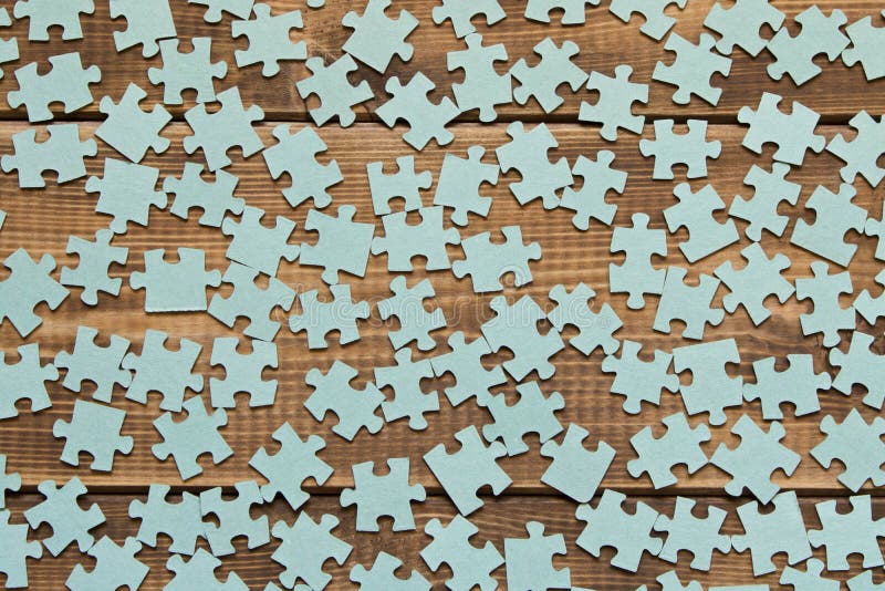 Puzzle. Many Puzzle Pieces on a Wooden Table Stock Image - Image of ...