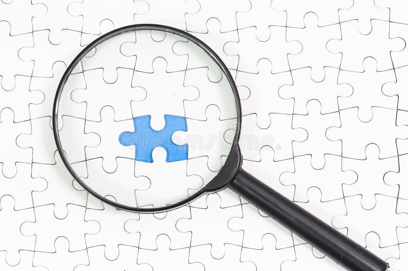 A Puzzle with One Piece Missing and a Magnifying Glass. Business and ...