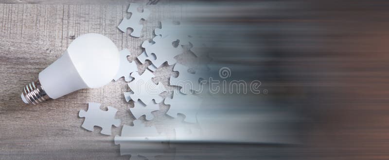 Puzzle Pieces and a Light Bulb on the Table Stock Photo - Image of ...