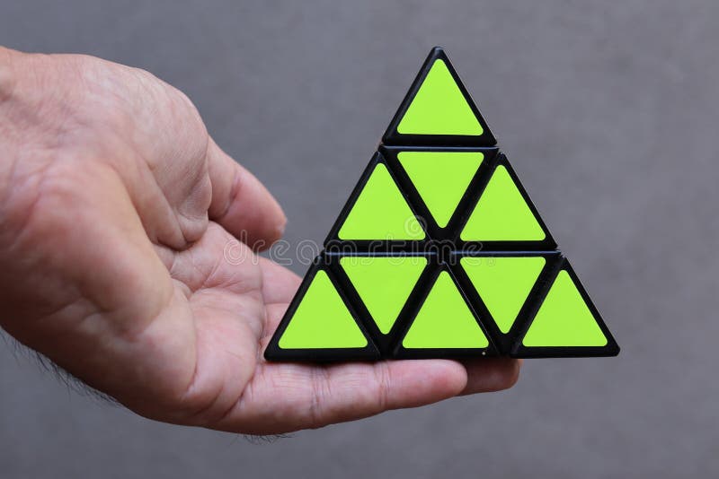 A Puzzle in the Shape of a Triangle in a Hand. Editorial Image - Image ...