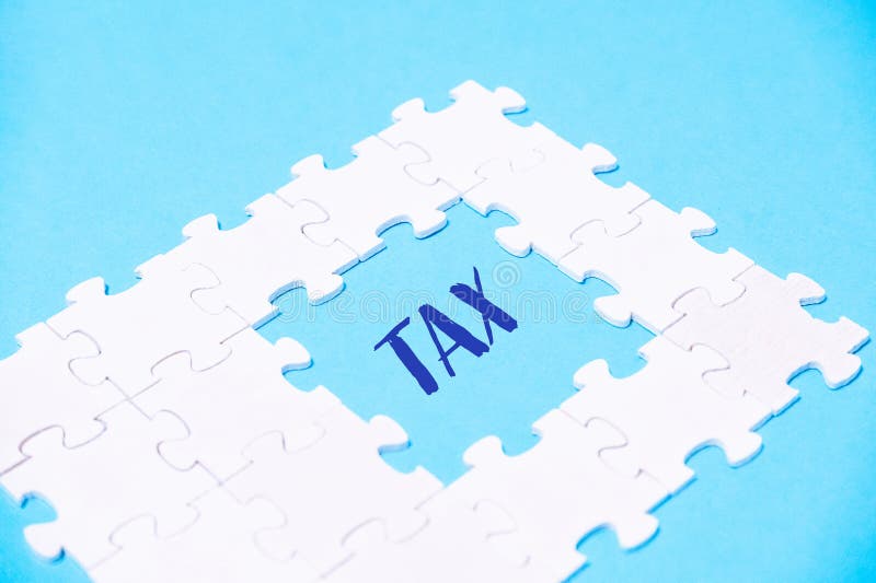 A Puzzle with the Word Tax Written in Blue on it Stock Photo - Image of ...