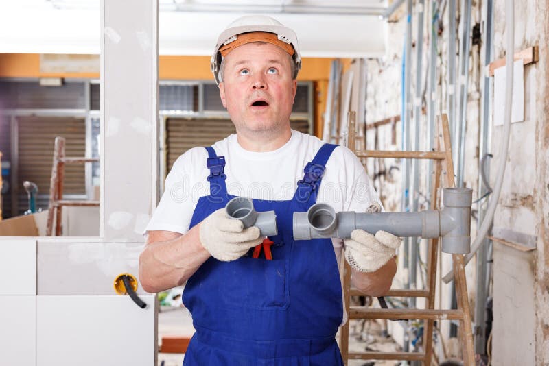 Puzzled Builder with Plastic Pipes Stock Image - Image of looking ...