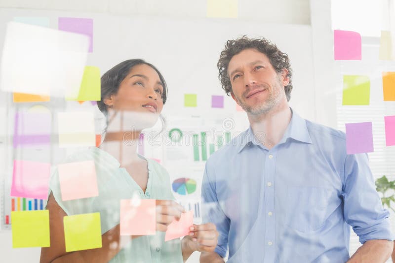 Puzzled Business Team Looking Post Its on the Wall Stock Image - Image ...
