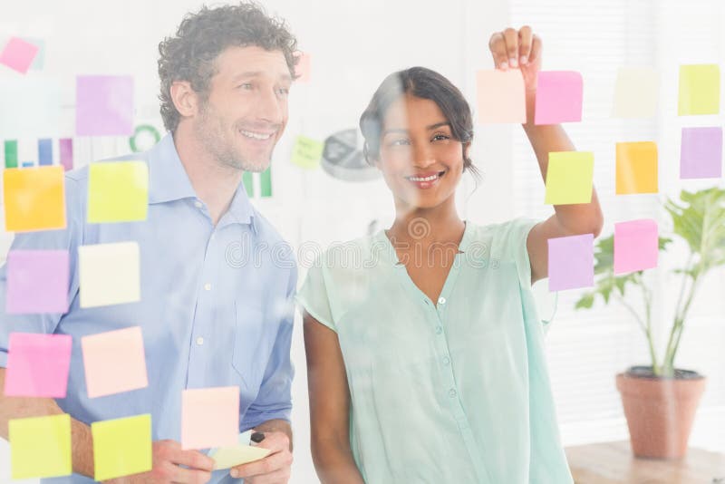 Puzzled Business Team Looking Post Its on the Wall Stock Photo - Image ...