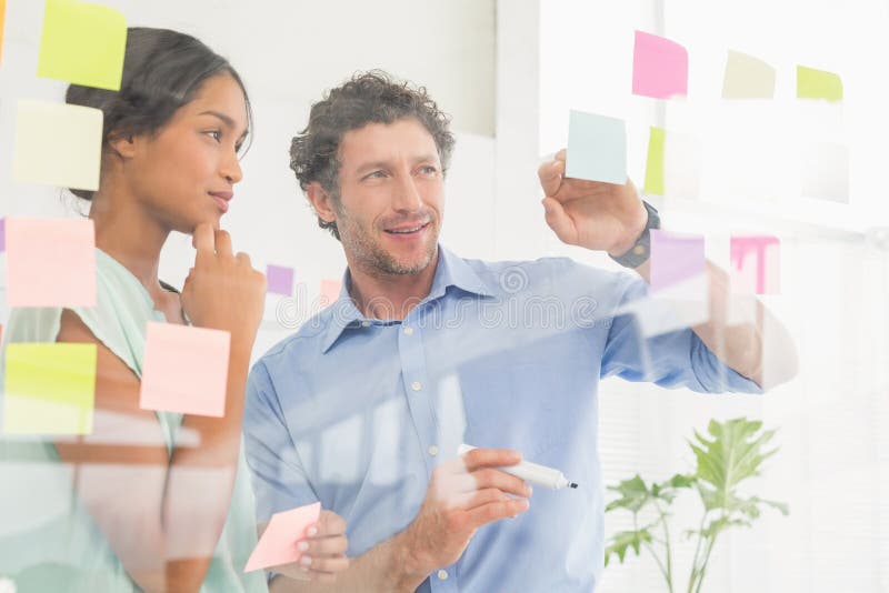 Puzzled Business Team Looking Post Its on the Wall Stock Image - Image ...