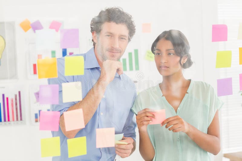 Puzzled Business Team Looking Post Its on the Wall Stock Photo - Image ...