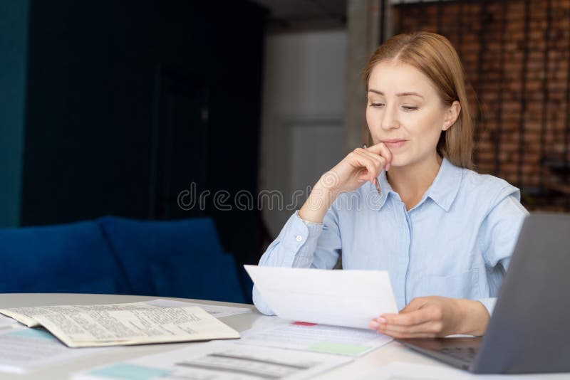Puzzled Businesswoman Reading Document in Home Office Stock Image ...
