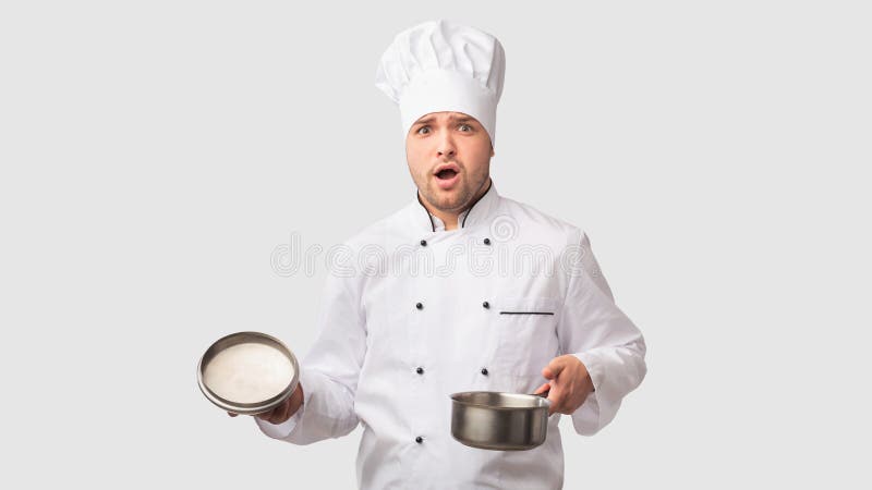Puzzled Cook Man Opening Saucepan Standing on White Studio Background ...