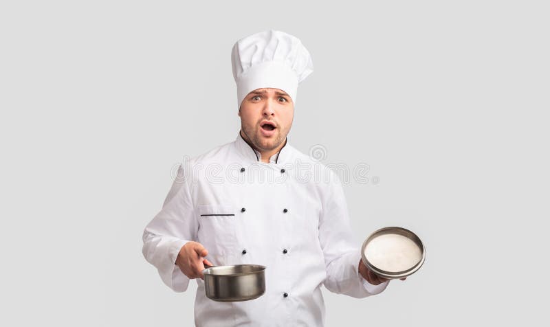 Puzzled Cook Man Opening Saucepan Standing on White Studio Background ...