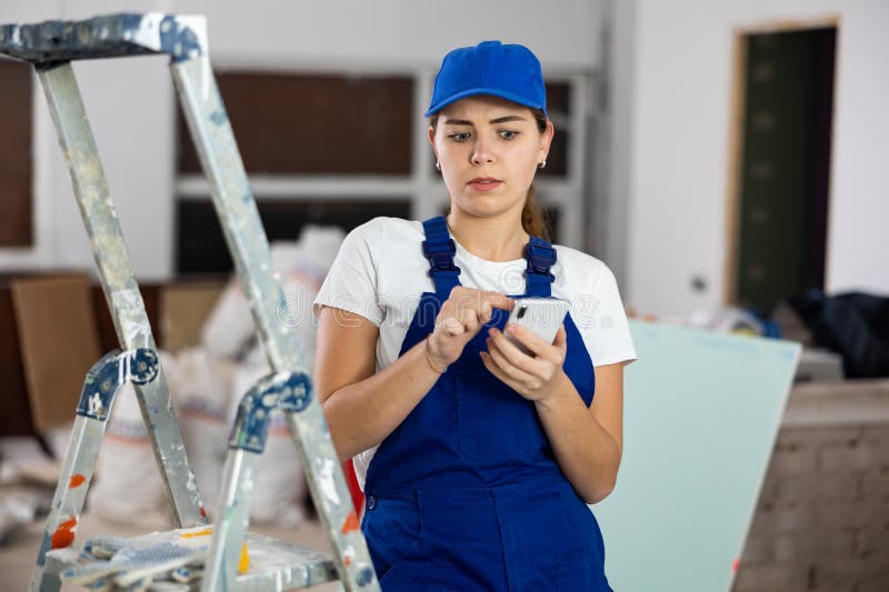 Puzzled Female Builder Reading Message Smartphone Construction Site ...