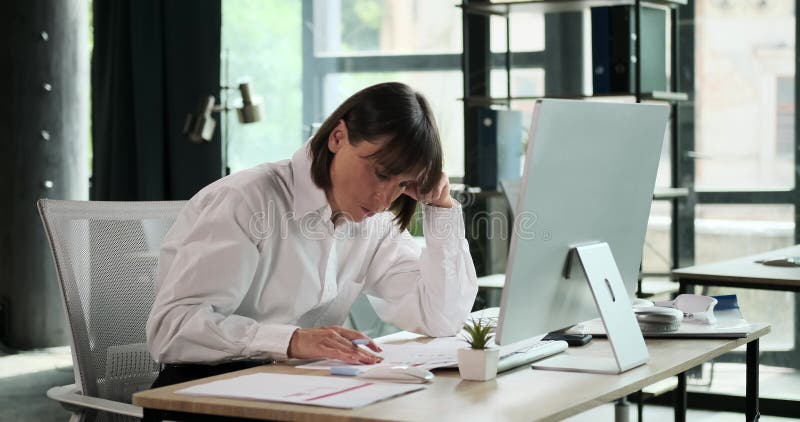 Puzzled Woman Working with Documents at the Office Desk Stock Video ...