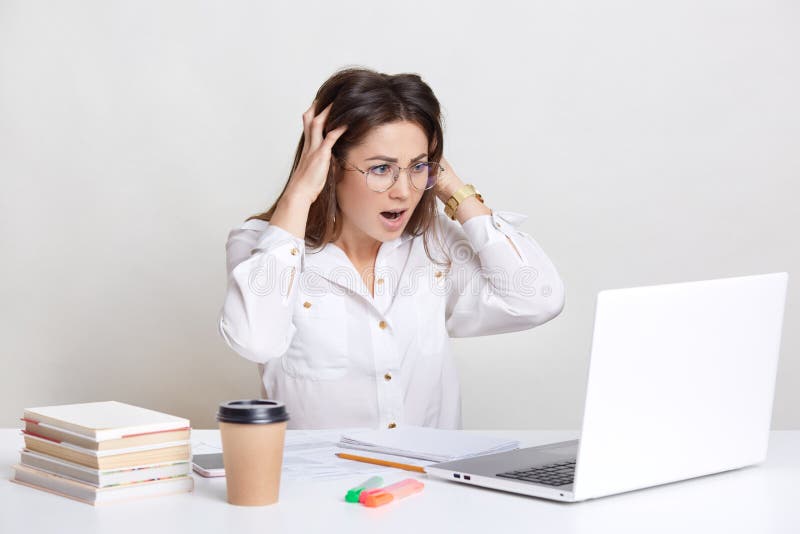 Puzzled Young European Female Student in Panic, Stares with Surprised ...