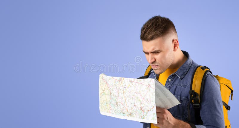 Puzzled Young Guy with Tourist Backpack and Map Over Blue Studio ...