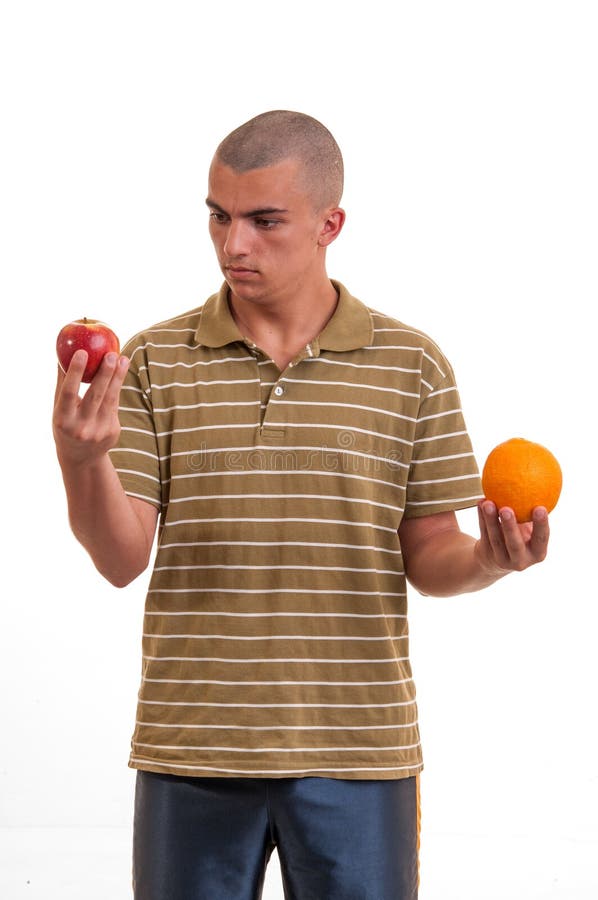 Puzzled Young Man Confused, Choice between an Apple an an Orange Stock ...